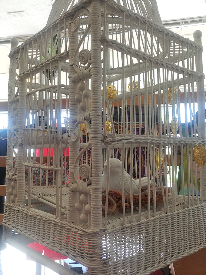 Decorative birdcage that's pure vintage whimsy. This white wicker creation could hold anything from air plants to fairy lights in your Florida sunroom.