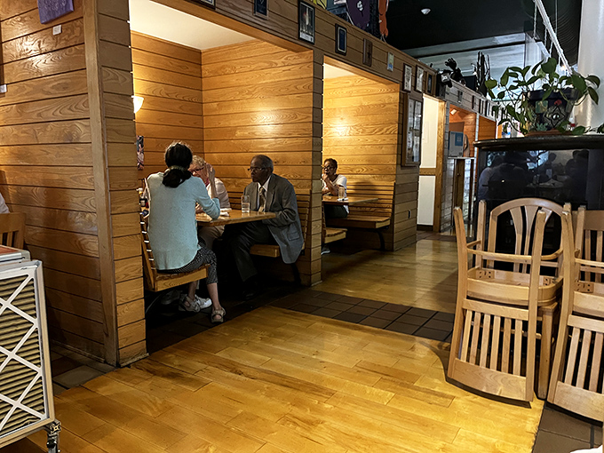 Conversation flows as easily as coffee in these cozy wooden booths. Tommy's mastered the art of creating spaces where people actually talk to each other.