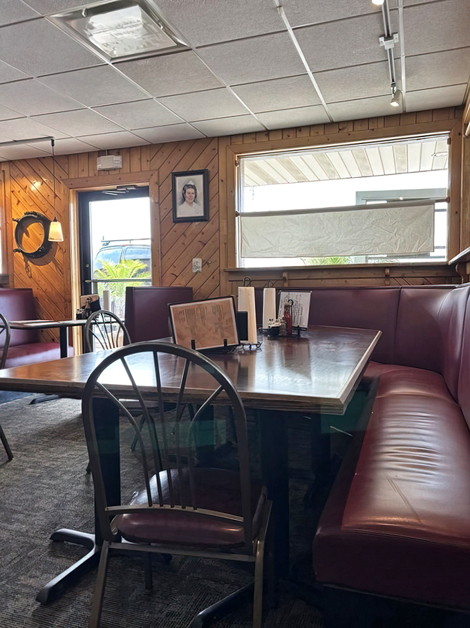 Burgundy booths that have cradled countless happy diners through decades of seafood feasts. Where comfort meets function in perfect harmony.