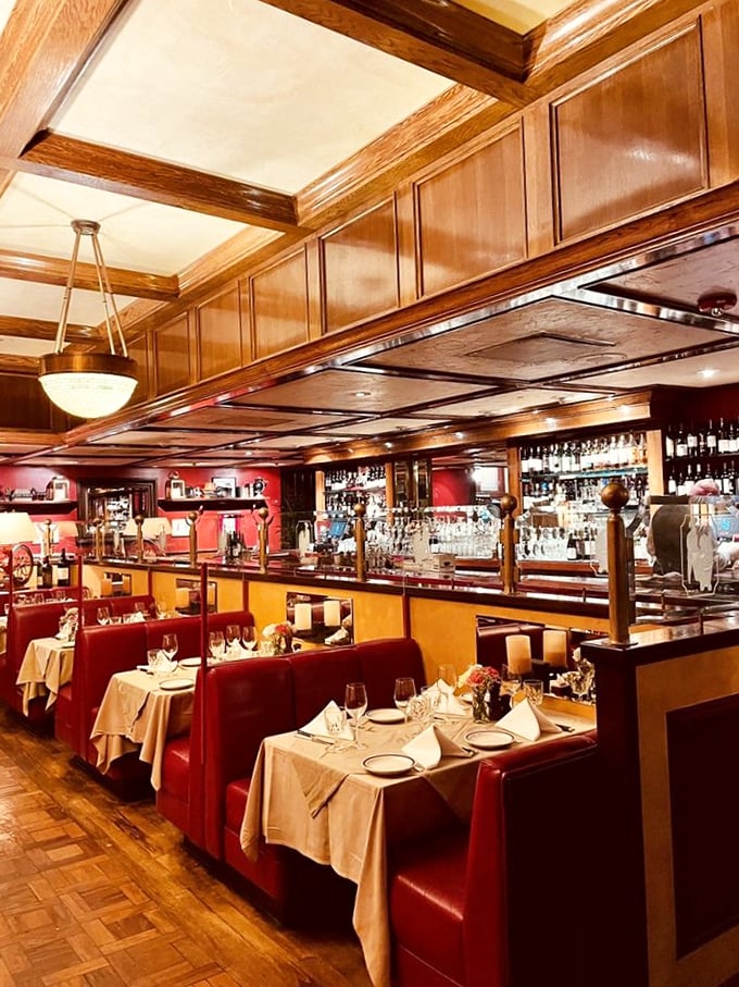 Red leather booths create intimate dining islands in a sea of conversation. The perfect setting for both first dates and fiftieth anniversaries.