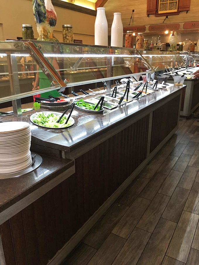 The salad bar stretches like a green oasis, a symbolic gesture toward nutrition before you demolish the mac and cheese.