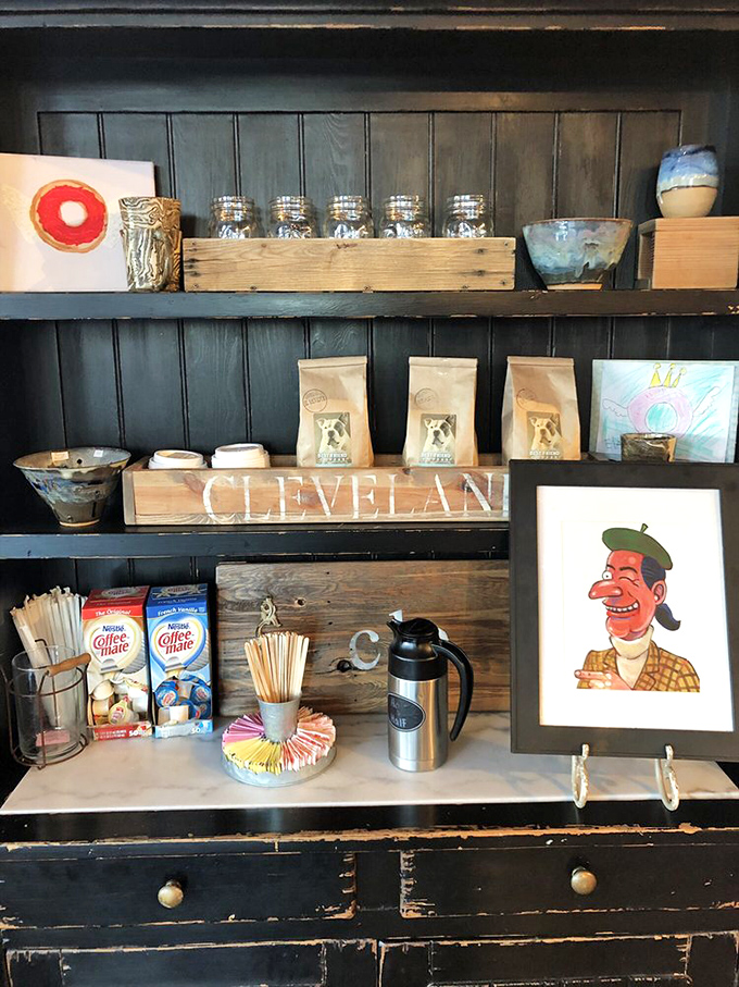 The coffee station&mdash;because every great donut deserves a proper liquid companion. That "CLEVELAND" sign reminds you exactly where this donut magic happens.