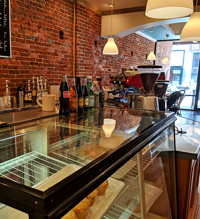Where coffee meets craftsmanship. The exposed brick wall and gleaming equipment promise beverages worthy of the culinary treasures they'll accompany.