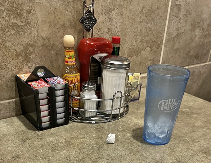 The condiment caddy&mdash;unsung hero of diner dining. That tabletop collection transforms good meals into personalized perfection.