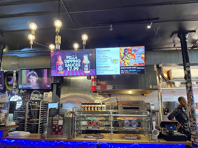 Behind this counter, pizza magic happens nightly, transforming simple ingredients into neighborhood legends worth celebrating and sharing.