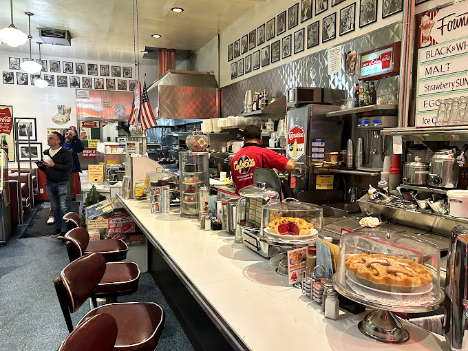 The classic diner counter where conversations flow as freely as the coffee and friendships are born.