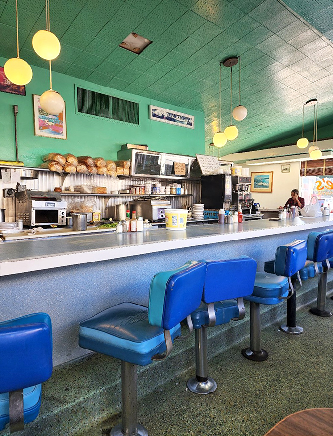 The counter seating&mdash;where solo diners become temporary family and the short-order ballet unfolds before your eyes. Those blue swivel stools have heard a million stories.