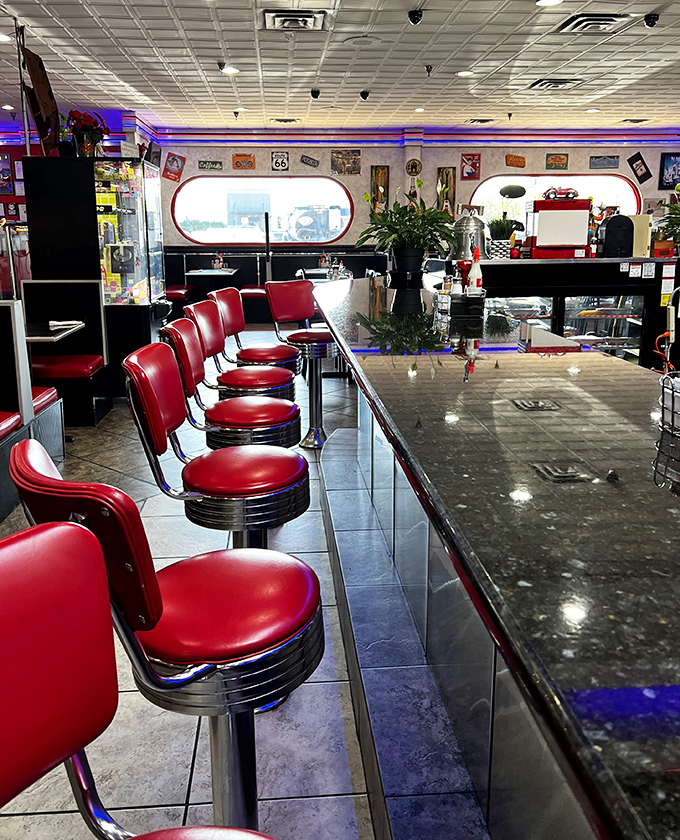 Those classic red counter stools aren't just seating—they're front-row tickets to the culinary show. The chrome gleams with promises of coffee refills and friendly conversation.