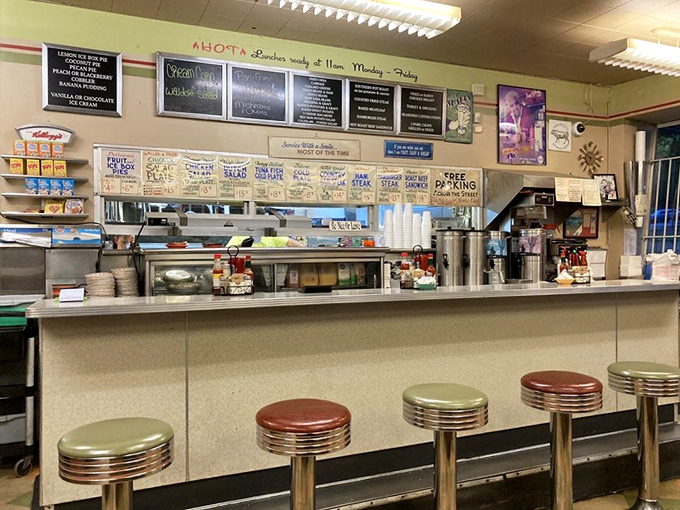 Classic counter seating where strangers become friends over coffee refills and the shared religion of good Southern cooking.
