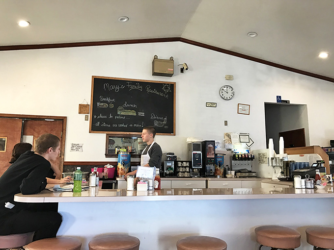 At the counter, where strangers become regulars and regulars become family, conversations flow as freely as the coffee refills.