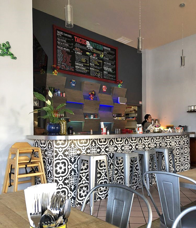 The counter's black and white tile pattern adds artistic flair, like the restaurant equivalent of a well-placed accessory.
