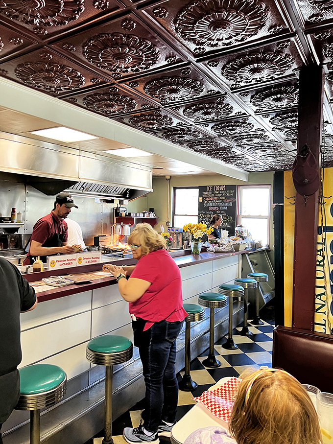 The counter space &ndash; where solo diners find community, coffee flows freely, and the ceiling tiles above have witnessed countless "I'll just have one more bite" moments.