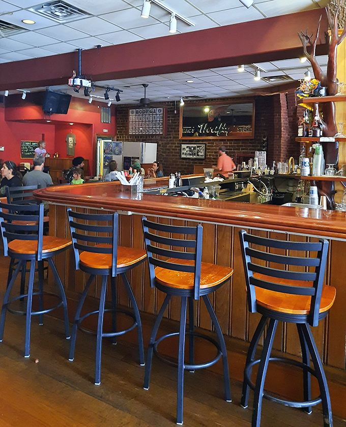 The welcoming bar area invites lingering conversations over drinks that taste like they were crafted with actual care.