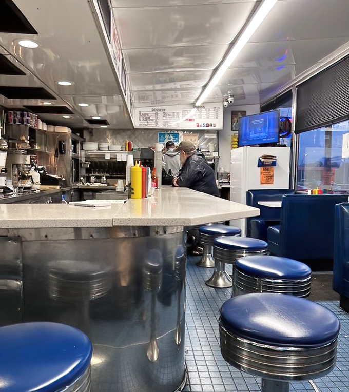 Counter dining: where strangers become temporary neighbors united by the universal language of "pass the ketchup, please."