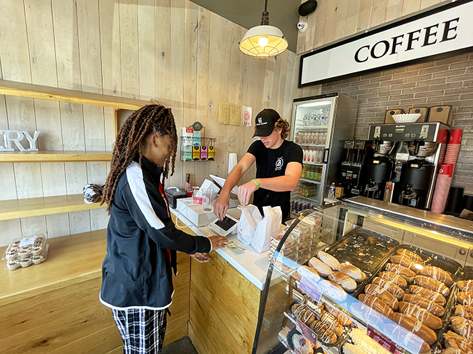 The sacred transaction: donuts passing from maker to eager hands. A ritual as old as time, but never this delicious.