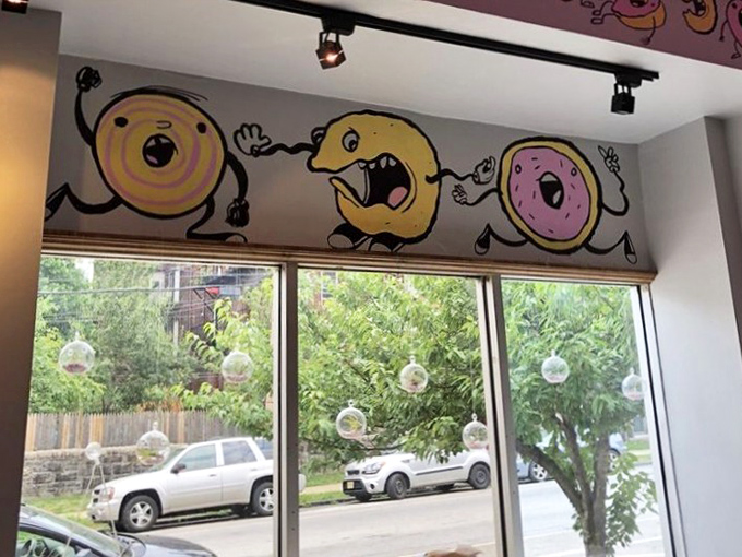 Whimsical donut characters dance across the walls – a playful reminder that serious food doesn't have to take itself too seriously.