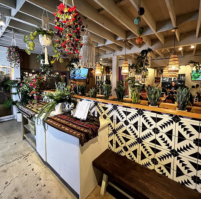 Hanging plants and vibrant flowers transform the ceiling into a living art installation. Dining here feels like a secret garden party where everyone's invited.