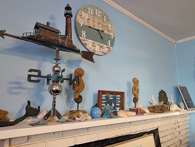 Coastal kitsch done right &ndash; weathered seahorses and lighthouse decor that somehow feels authentic rather than touristy. That clock runs on "seafood time."