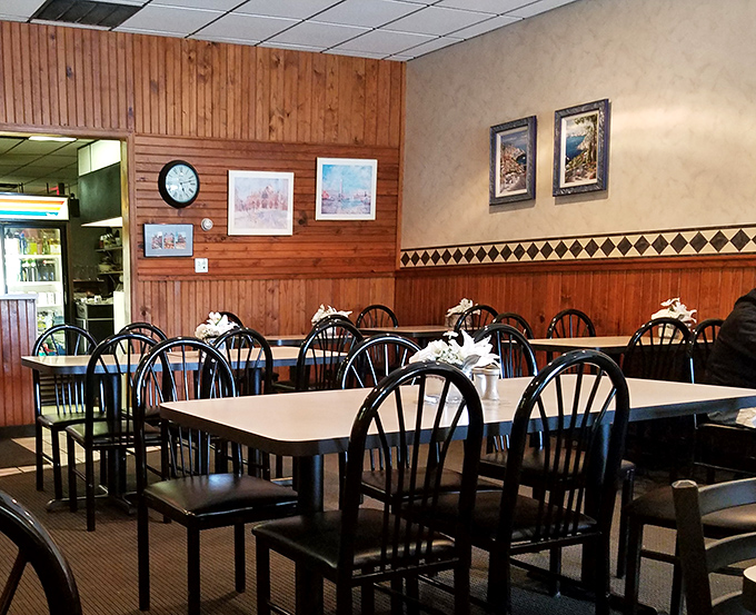 The diamond pattern border adds a touch of subtle elegance to wood-paneled walls that have absorbed decades of happy conversations and garlic-scented air.