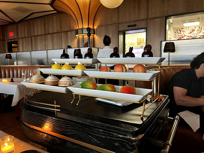 The dessert cart—civilization's greatest achievement since indoor plumbing. Those gleaming pastries and fresh fruits are basically edible jewelry.