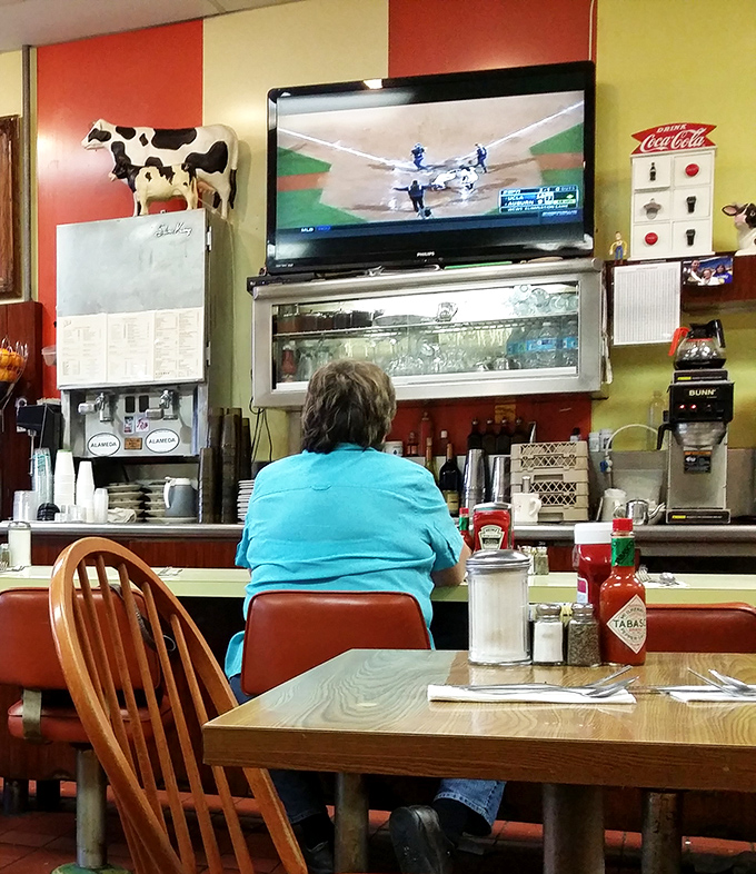A diner where the TV might show baseball, but the real American pastime is happening on your plate. Red and yellow walls that say "happiness served here."
