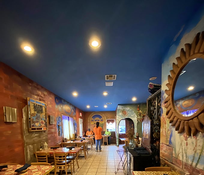 The blue ceiling hovers like a Mexican sky while diners below embark on flavor journeys. Those brick archways frame each dining experience like a living painting.