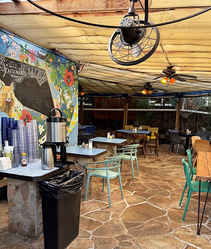 The outdoor patio offers a whimsical escape from the city bustle. String lights and colorful art create the perfect backdrop for pancake indulgence.