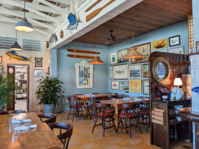 Blue walls adorned with maritime treasures create a dining room that feels like the captain's quarters of the coolest ship you've ever boarded.