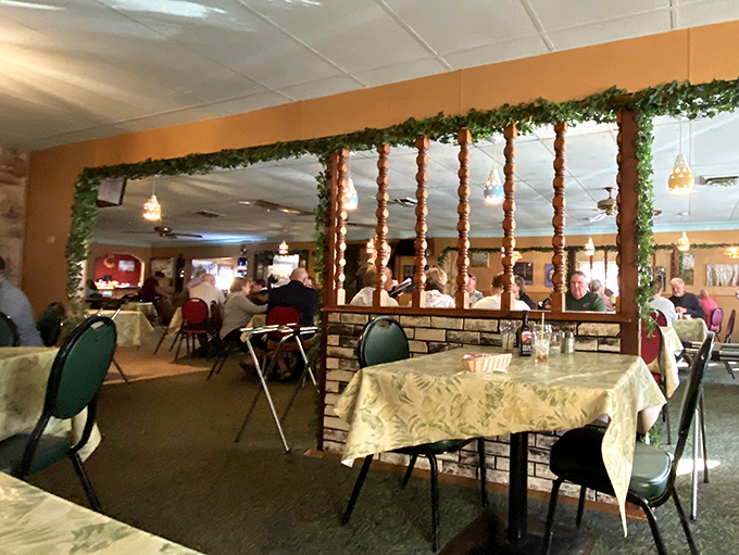 Room dividers adorned with greenery separate dining spaces&mdash;creating intimate pockets of conversation in the larger supper club landscape.