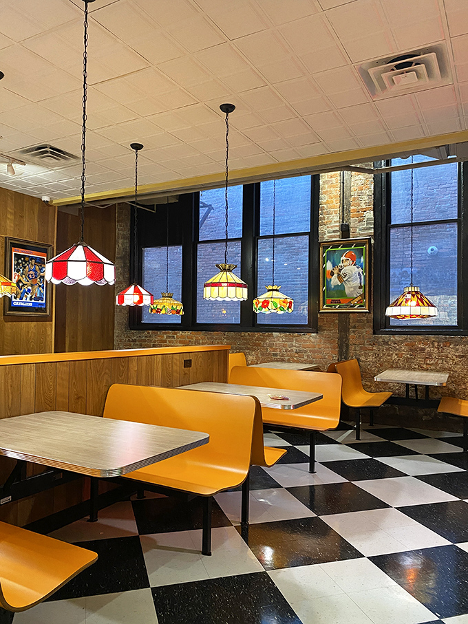 Stained glass pendant lamps cast a warm glow over orange booths. Pizza church is now in session, and everyone's invited.