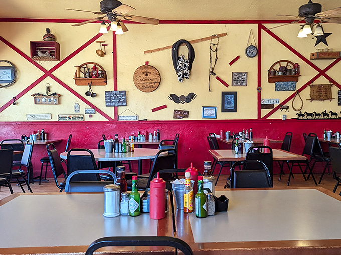 Western memorabilia adorns walls painted sunrise-yellow and sunset-red, creating the perfect backdrop for hearty meals and heartier conversations.