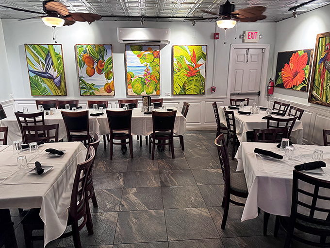 The dining room balances elegance with island casual&mdash;white tablecloths say "special occasion" while tropical artwork reminds you flip-flops are perfectly acceptable footwear.