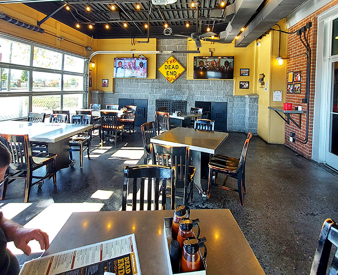 Sunlight streams through windows illuminating tables where barbecue dreams come true. Notice the sauce bottles standing ready like faithful soldiers.