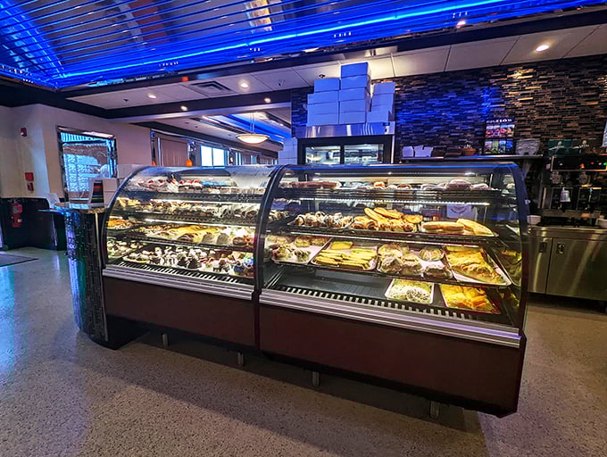 That dessert case isn't displaying pastries—it's showcasing edible works of art. Each shelf offers a different path to sweet satisfaction.