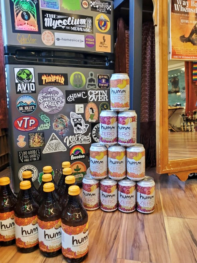 Even the beverages get the vintage treatment, with Humm kombucha cans stacked like a shrine to gut health amid nostalgic stickers.