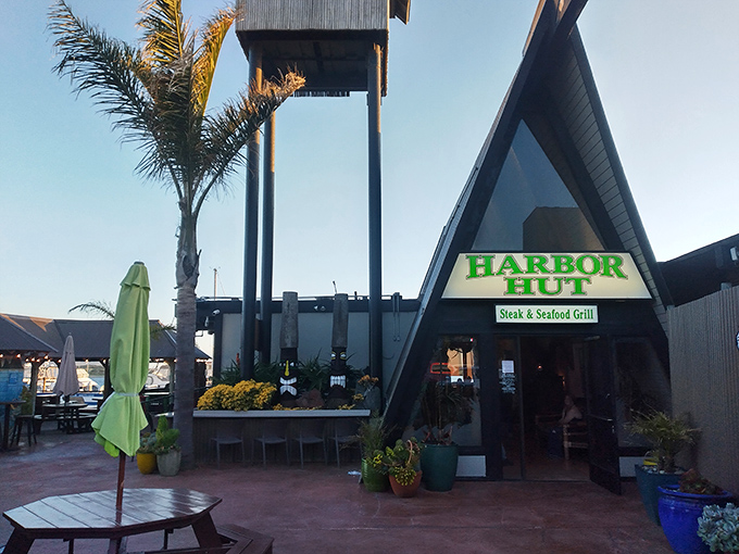 The entrance beckons with palm trees and promise&mdash;a casual exterior that belies the serious food waiting inside.