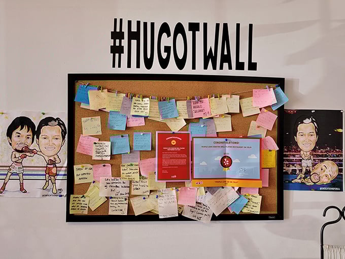 The "Hugot Wall" where diners leave notes of appreciation&mdash;like a analog Facebook where every review comes with actual human handwriting.