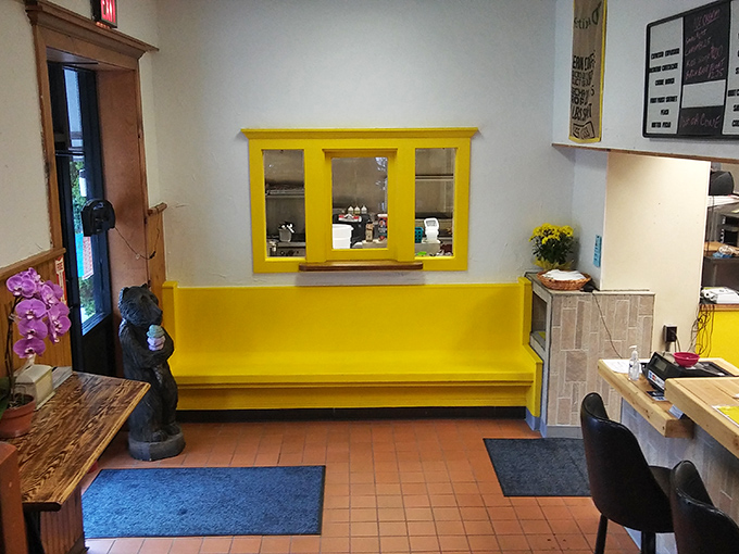 Splashes of sunshine yellow brighten the entryway, a cheerful prelude to the comfort food symphony that awaits beyond.