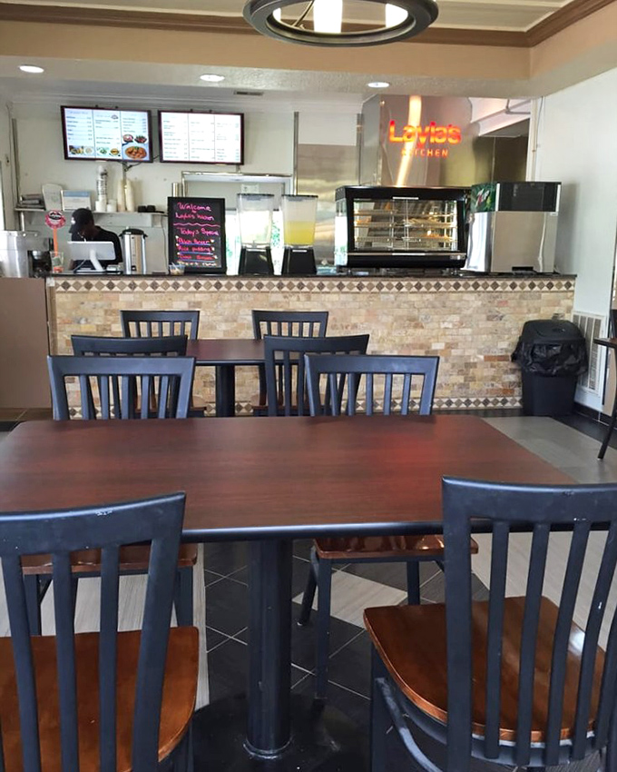 The counter view—where culinary dreams are born and the neon sign promises delights that extend far beyond your typical takeout experience.