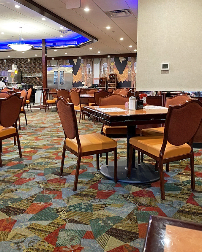 The geometric carpet leads your eye across the dining room where every table holds the promise of a meal worth remembering.