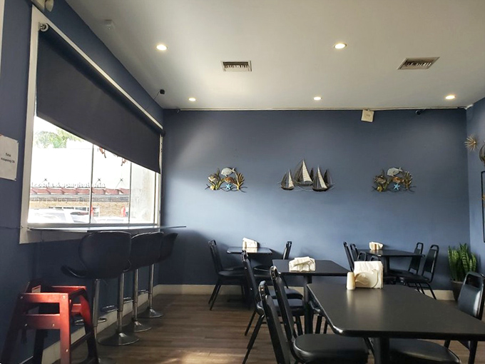 Navy blue walls and nautical accents create the perfect backdrop for seafood storytelling—like dining in the stylish captain's quarters of a ship that actually knows where the fish are.