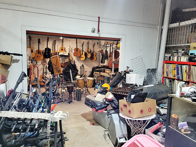 The musician's corner – where guitars hang like ripening fruit, each instrument holding the potential for campfire sing-alongs or garage band stardom.