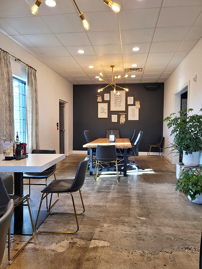 Plants, pendant lighting, and that statement accent wall create an atmosphere that says, "Yes, we care about food AND design."