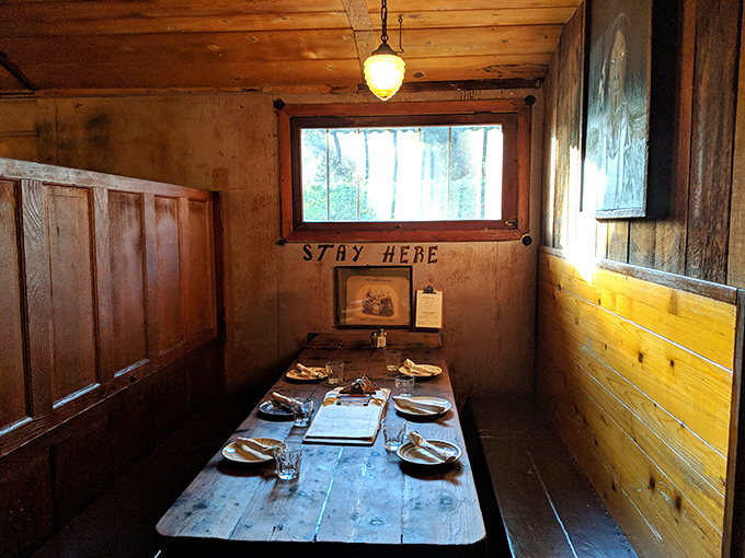 STAY HERE isn't just written on the wall&mdash;it's what your heart says when you enter this intimate dining nook with its wooden walls and perfectly set table.