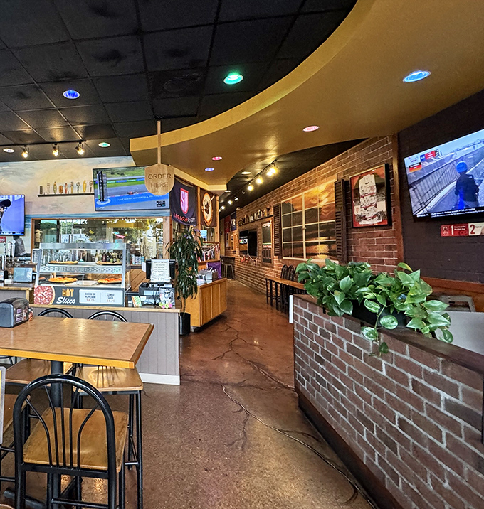 The warm glow of brick walls and wood paneling creates that neighborhood joint feeling – where everybody might not know your name yet, but they will.