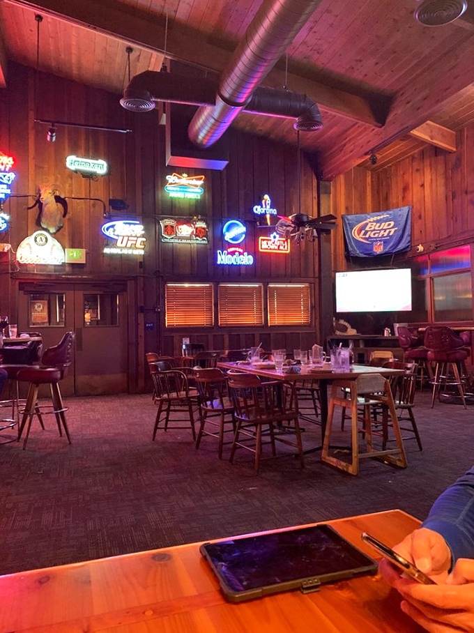 The bar area glows with neon nostalgia, offering a casual alternative where sports fans and food lovers find common ground over exceptional drinks.