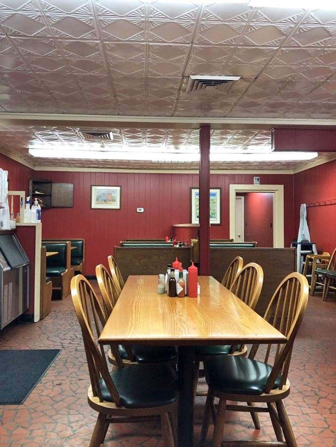 Red walls, pressed tin ceiling, and wooden dividers create barbecue's perfect stage. This isn't decoration&mdash;it's the backdrop for edible memories.