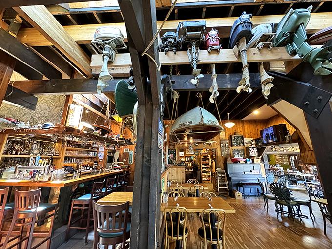 Vintage outboard motors hang from the ceiling like mechanical stalactites. They've retired from lake duty to become the world's most authentic restaurant decor.