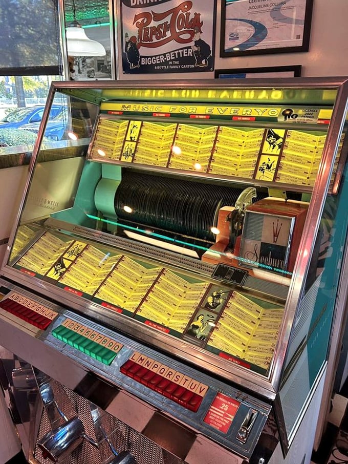 The jukebox stands as a glowing temple to nostalgia, where three quarters still buys you a time machine back to simpler days.
