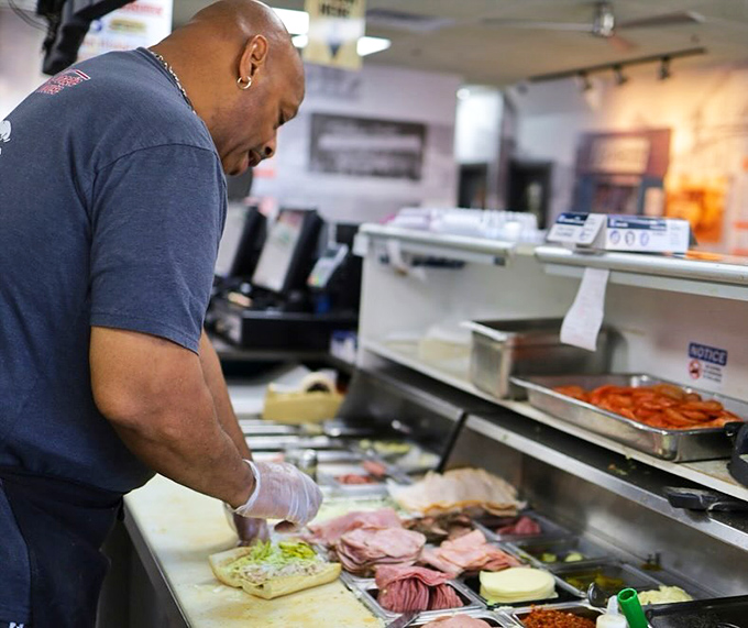 Behind the scenes magic – where sandwich artisans transform simple ingredients into edible masterpieces. The kitchen ballet begins.